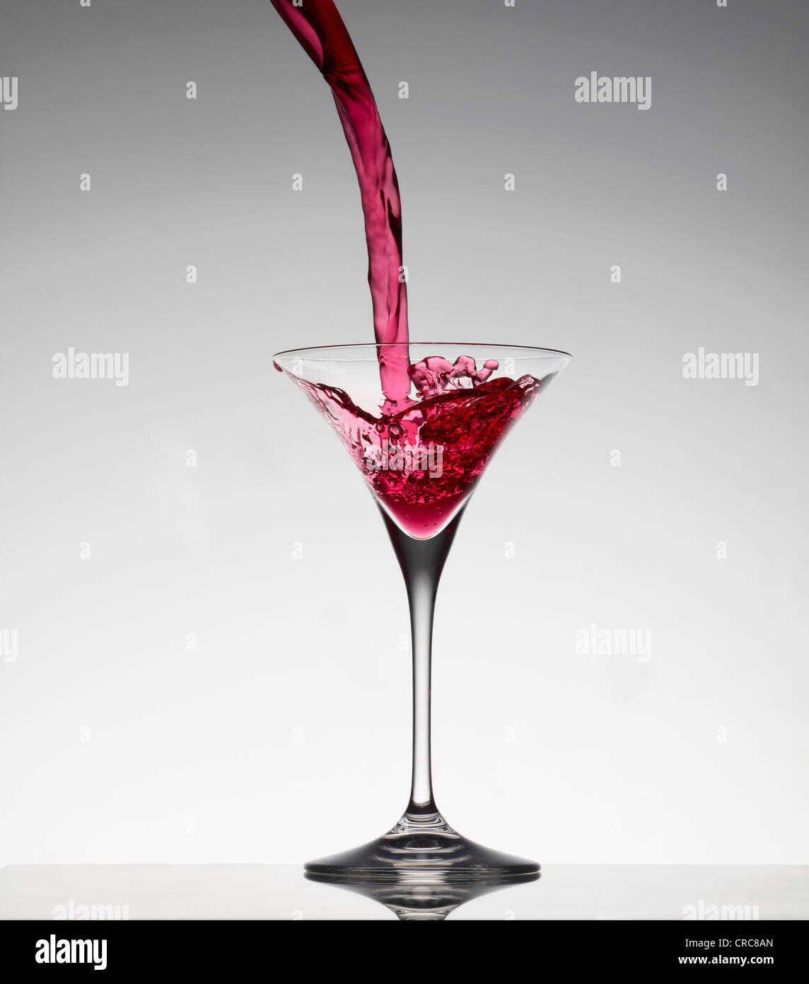 Cocktail pouring into martini glass Stock Photo - Alamy