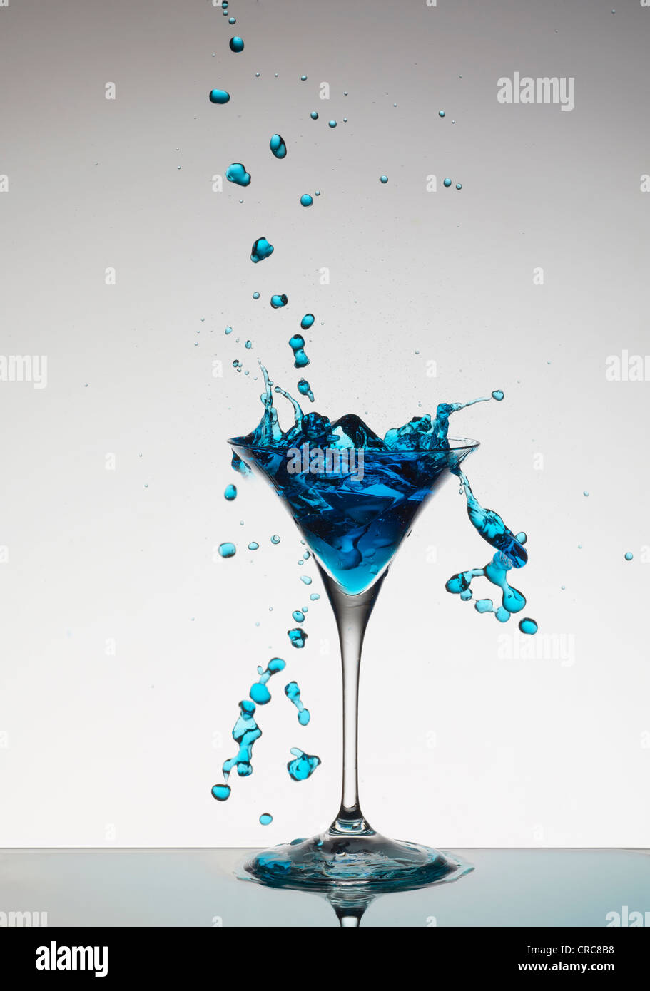 Cocktail splashing around martini glass Stock Photo - Alamy