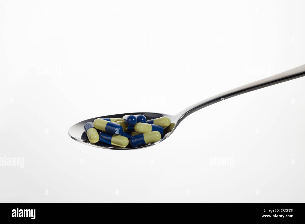 Close up of spoonful of pills Stock Photo - Alamy