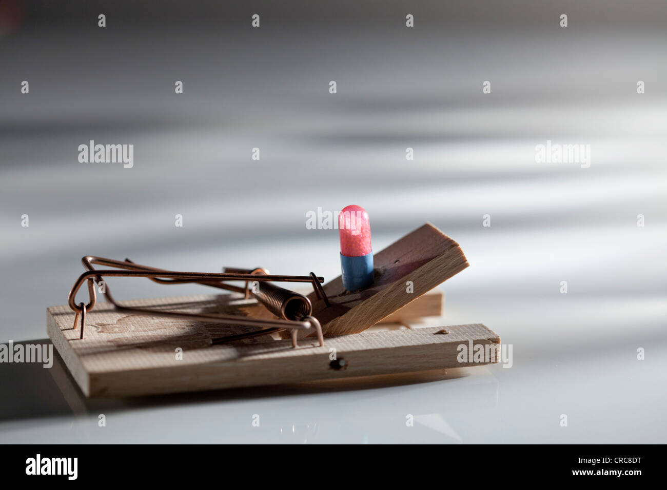 Pill on spring-loaded mouse trap Stock Photo - Alamy