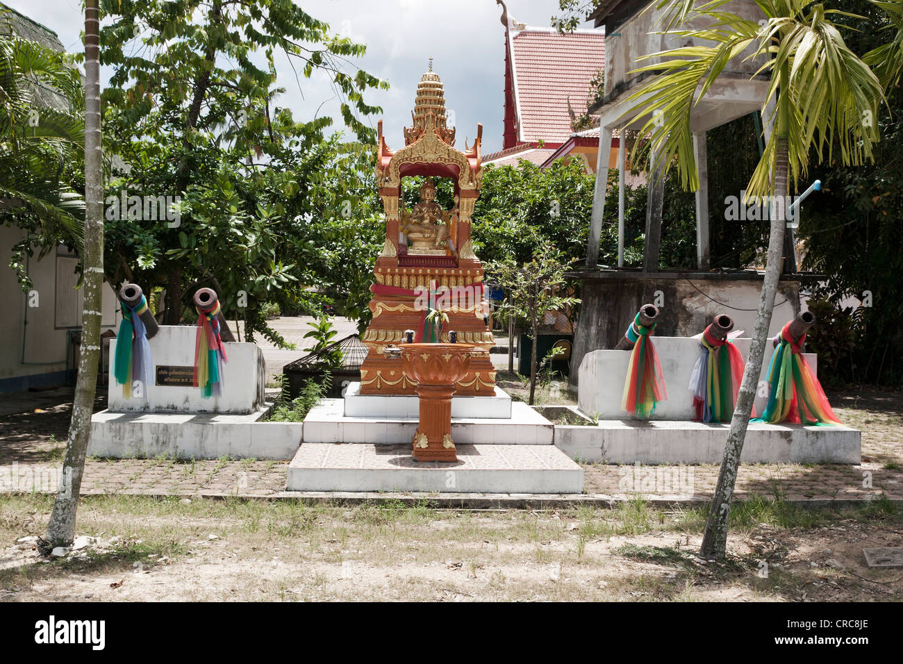 The contrast of Buddhism and guns at Wat phra Thong, Phuket, Thailand ...