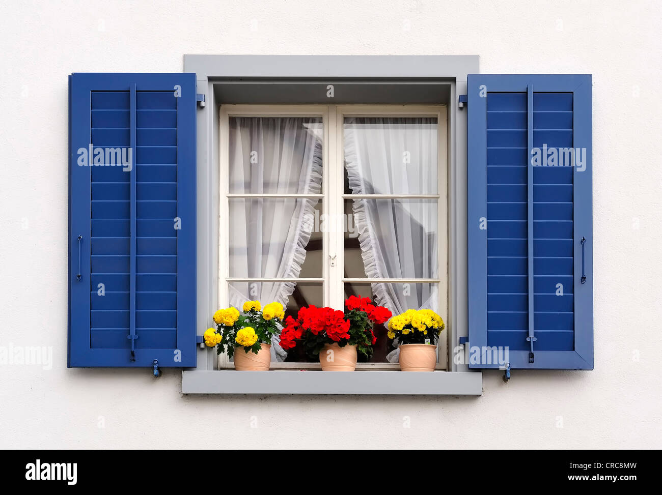 windows with flowers in hanging flower pots from switzerland Stock ...
