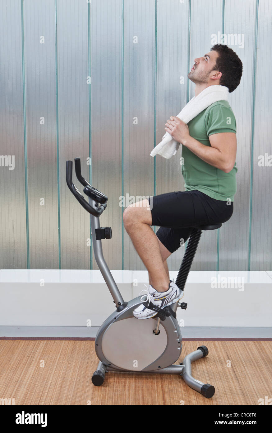 Man using exercise machine Stock Photo - Alamy