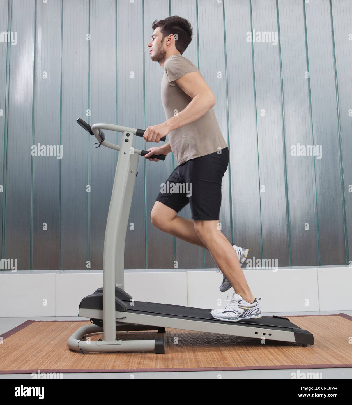 Man using exercise machine Stock Photo - Alamy