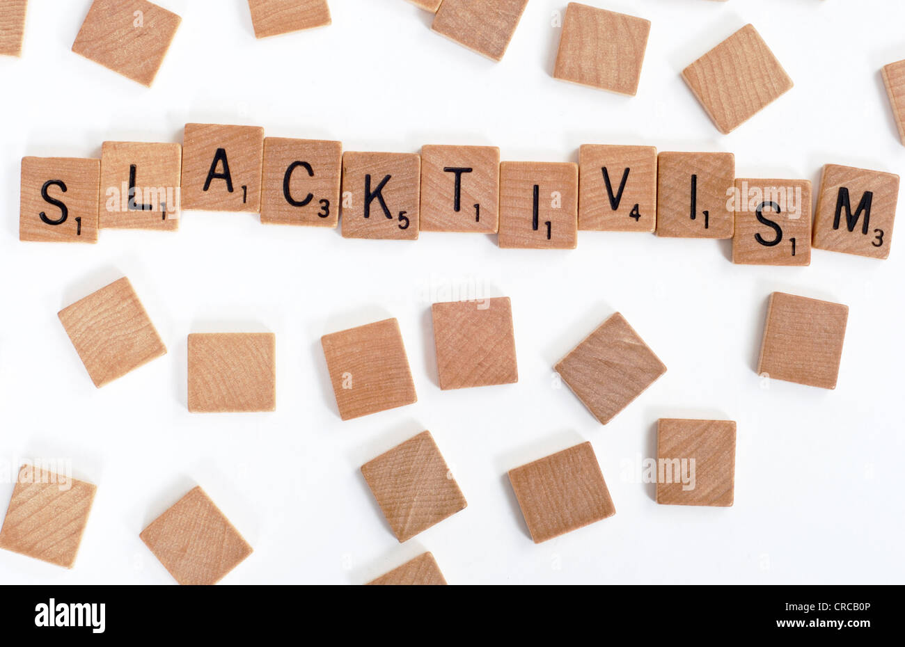 Wood Scrabble tiles spelling out the words 'Slacktivism'. On white ...