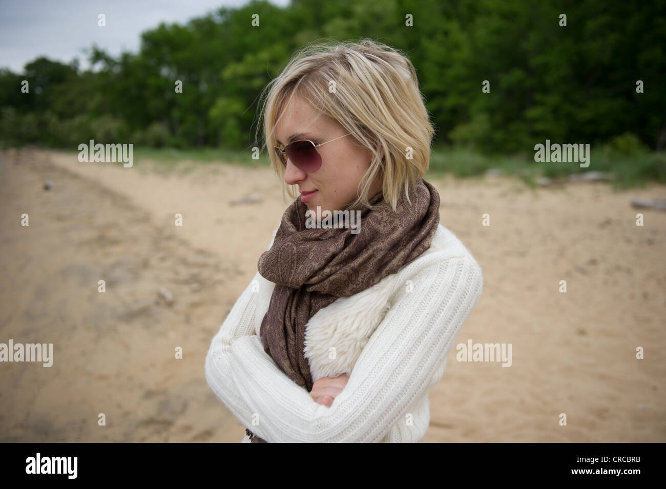 Young woman on cold beach alone Stock Photo - Alamy