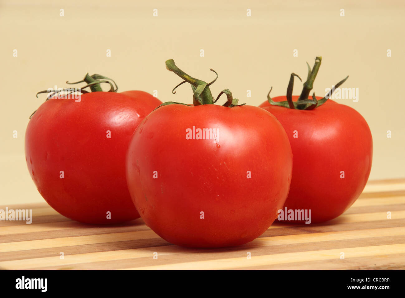 three red tomatoes Stock Photo - Alamy