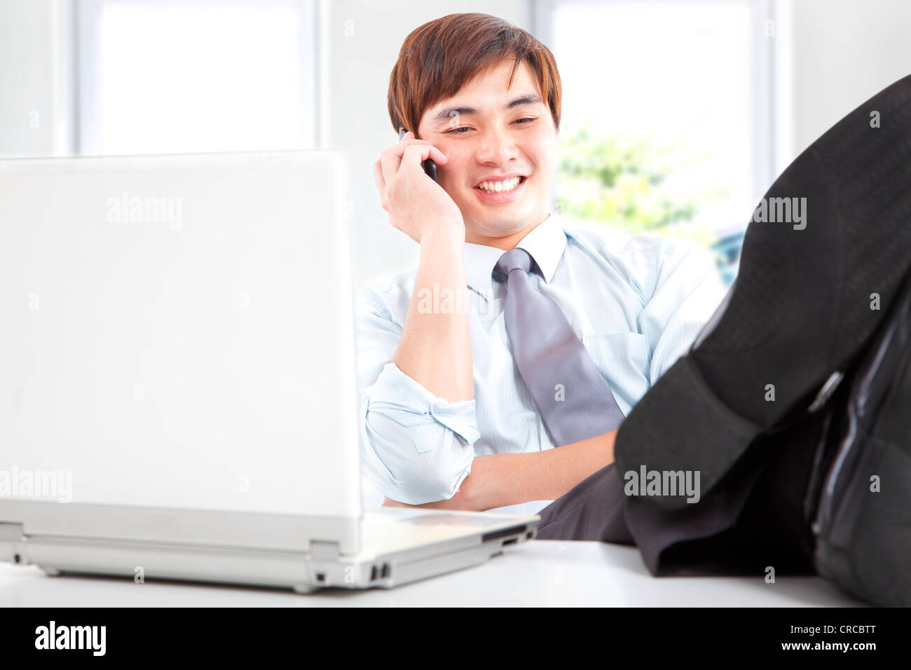 happy businessman taking a phone call in office Stock Photo - Alamy