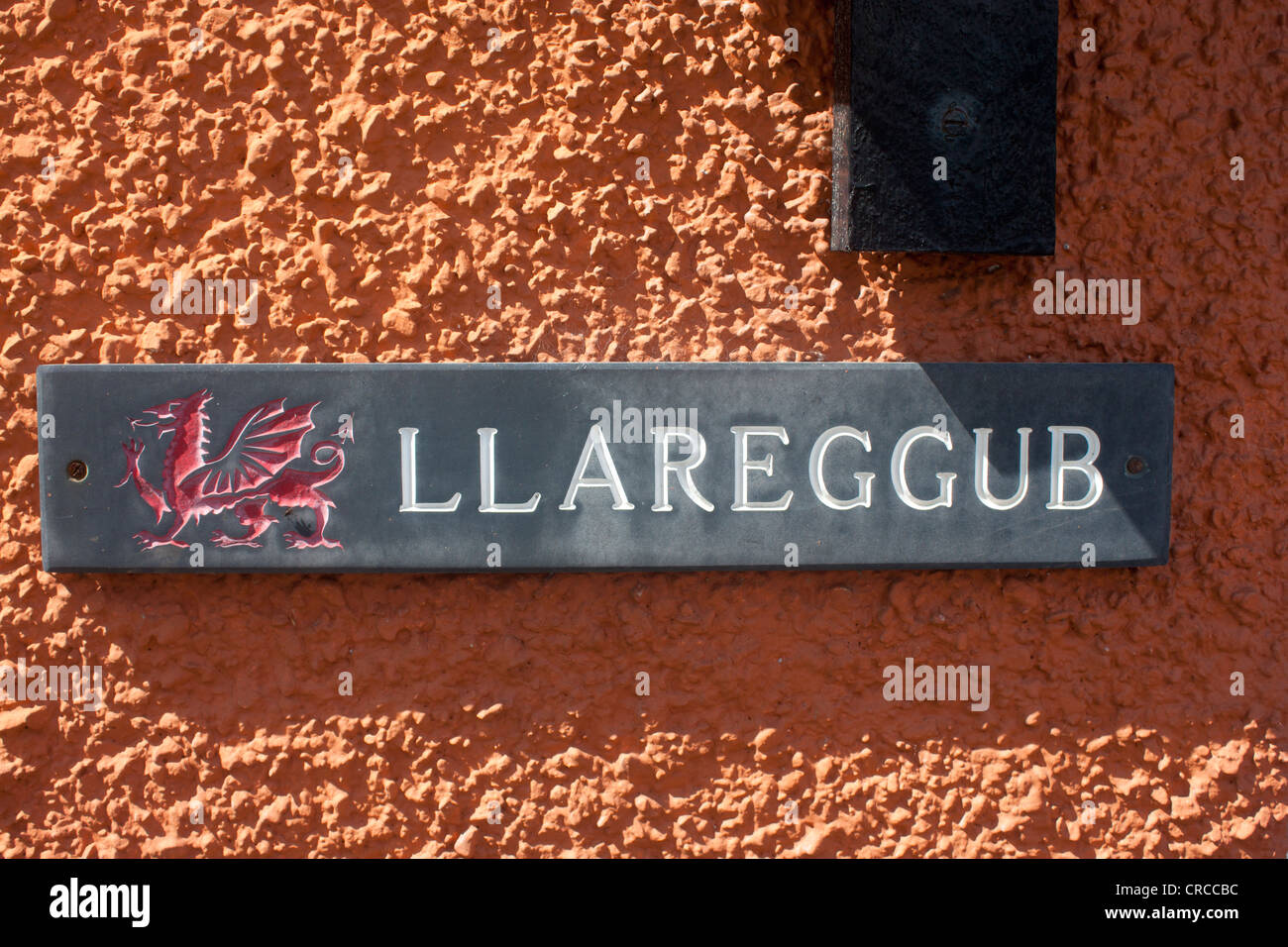 'Llareggub' slate name plate with red Welsh dragon on exterior of house ...