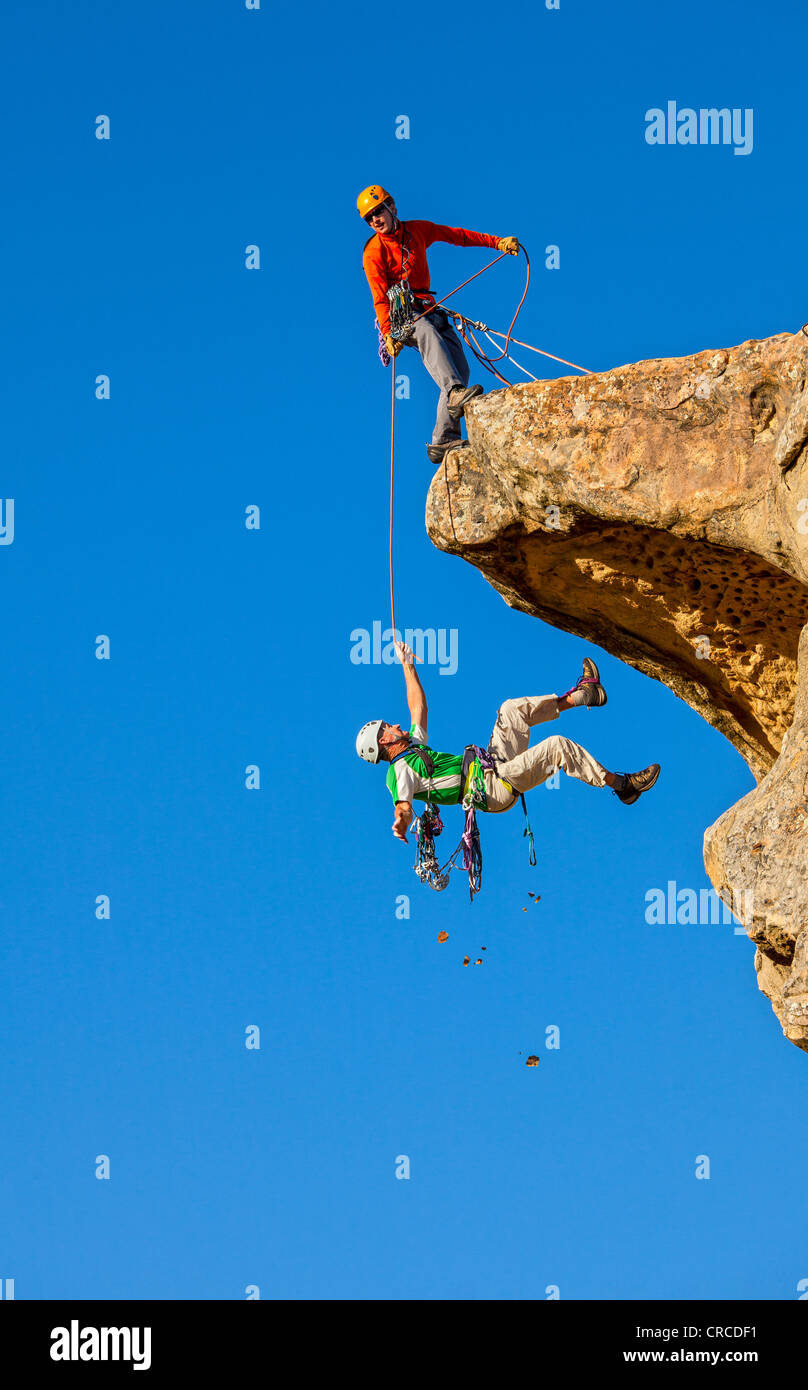 Climbing team struggle to the summit of a challenging rock mountain ...