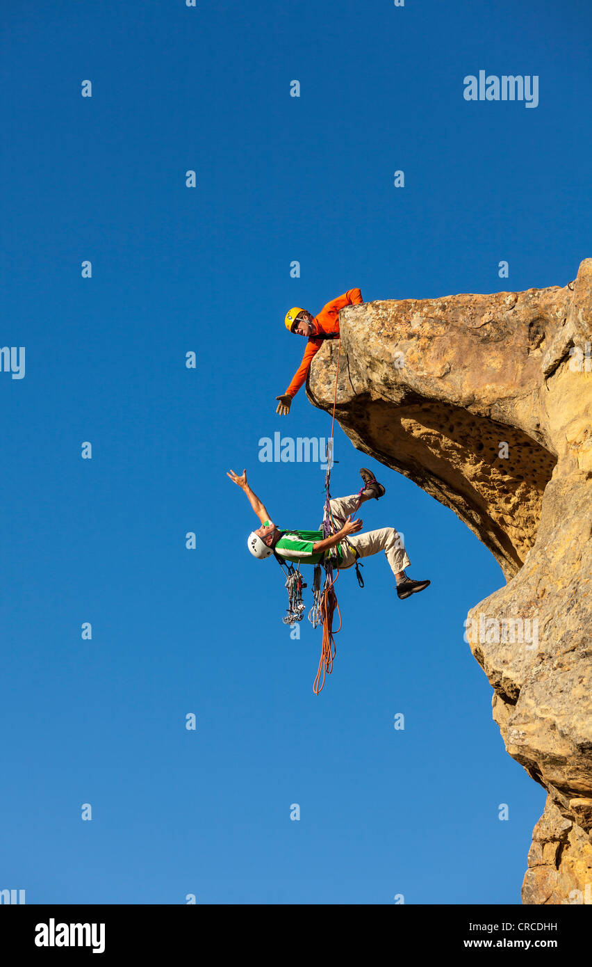 Climbing team struggle to the summit of a challenging rock mountain ...