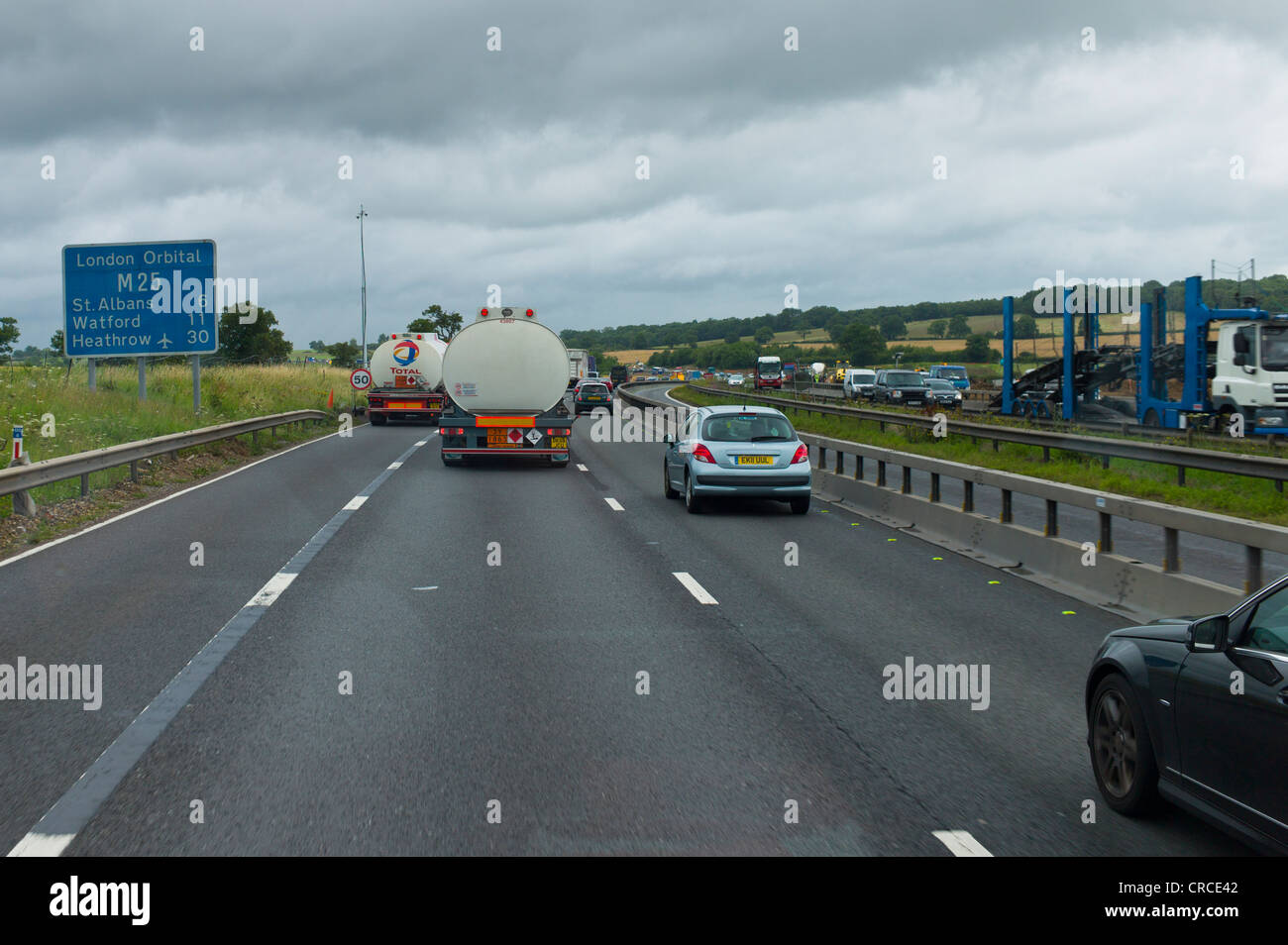 A busy section of the M25, London Orbital Motorway, with a lane closed ...