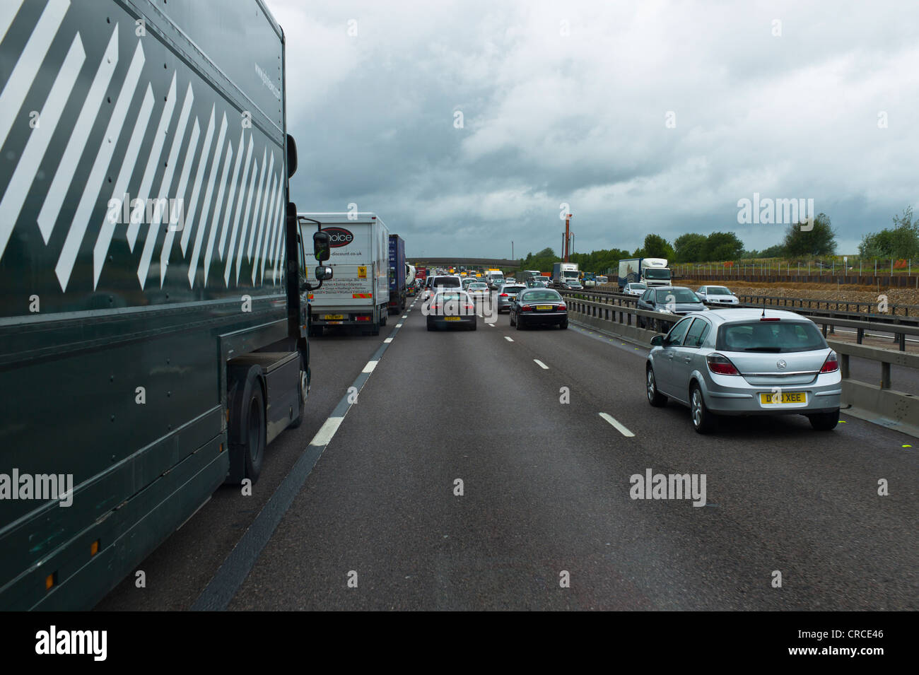 A busy section of the M25, London Orbital Motorway, with a lane closed ...