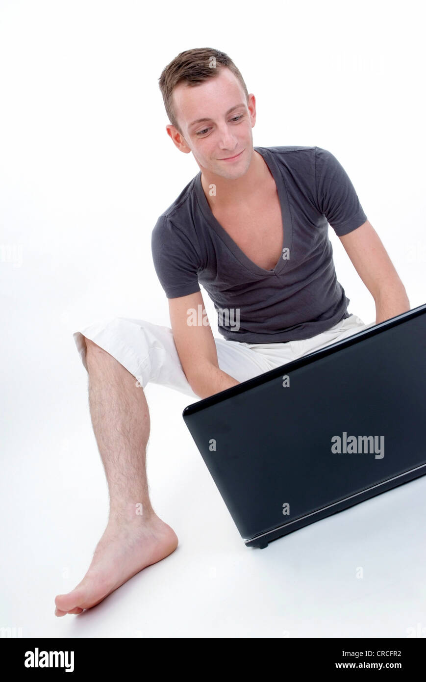 young man uses a laptop Stock Photo - Alamy