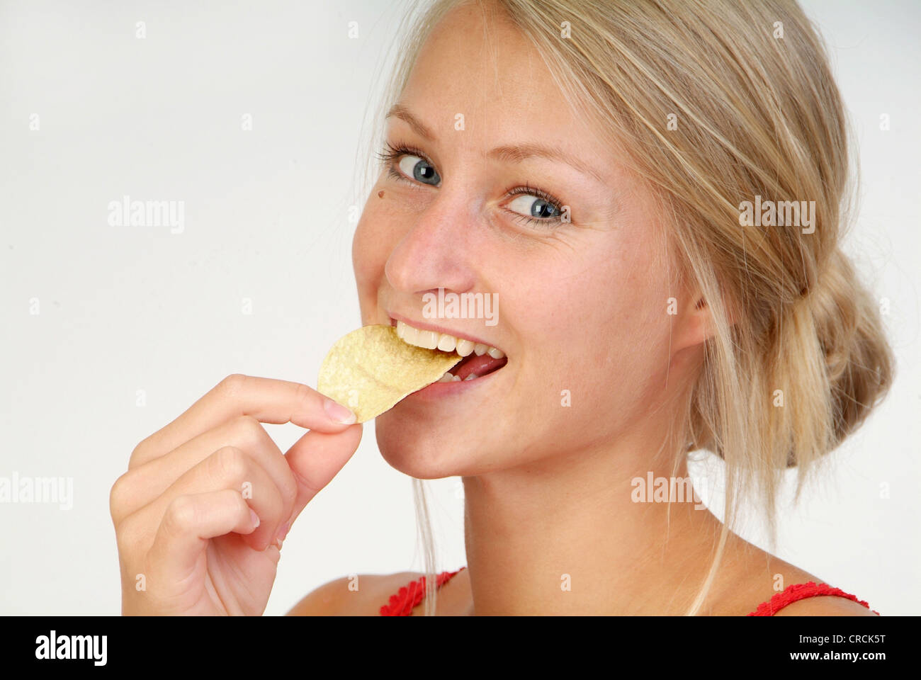 Young blond woman eats chips hi-res stock photography and images - Alamy