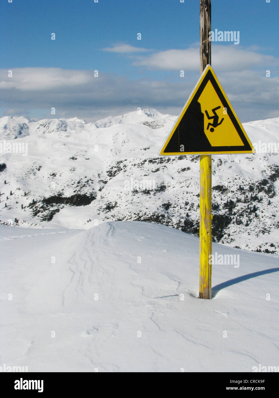 Sign in snowy mountain scenery of a skiing area warning against danger ...
