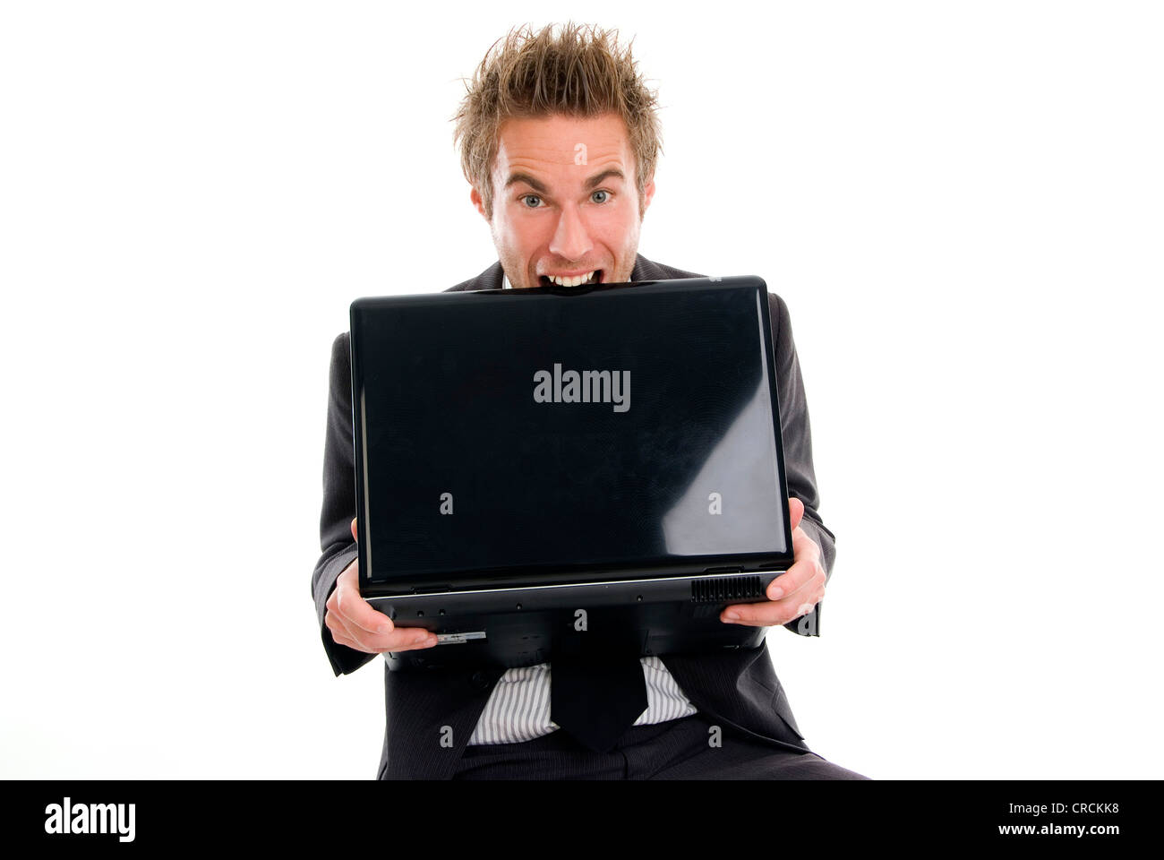 young businessman bites in laptop Stock Photo - Alamy