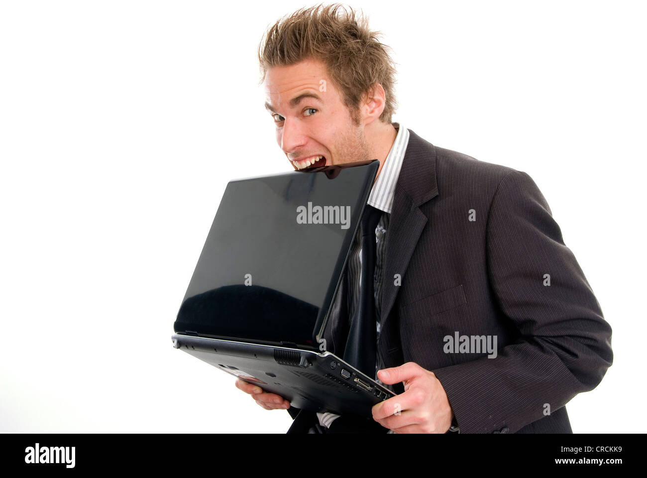 young businessman bites in laptop Stock Photo - Alamy