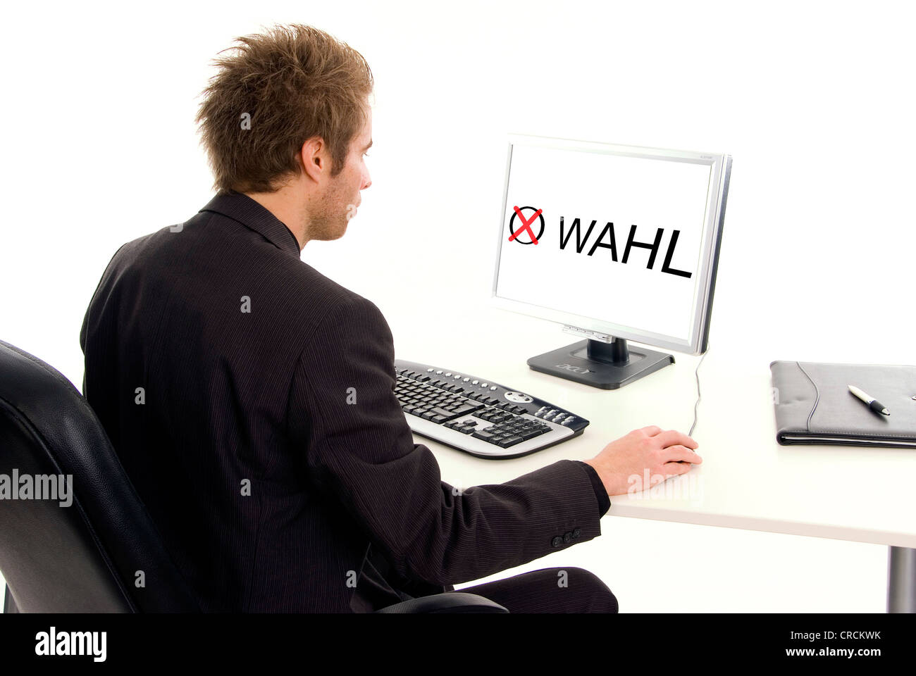 e-voting, a man sitting at a desk at his computer Stock Photo - Alamy