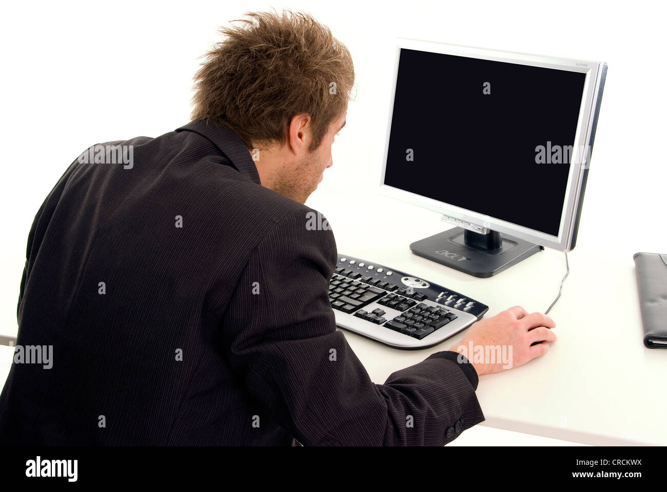 man sitting at a desk in front of a black screen Stock Photo - Alamy
