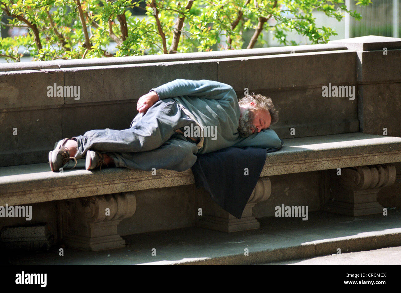 Spain, a homeless man is sleeping on a bench in Barcelona Stock Photo ...