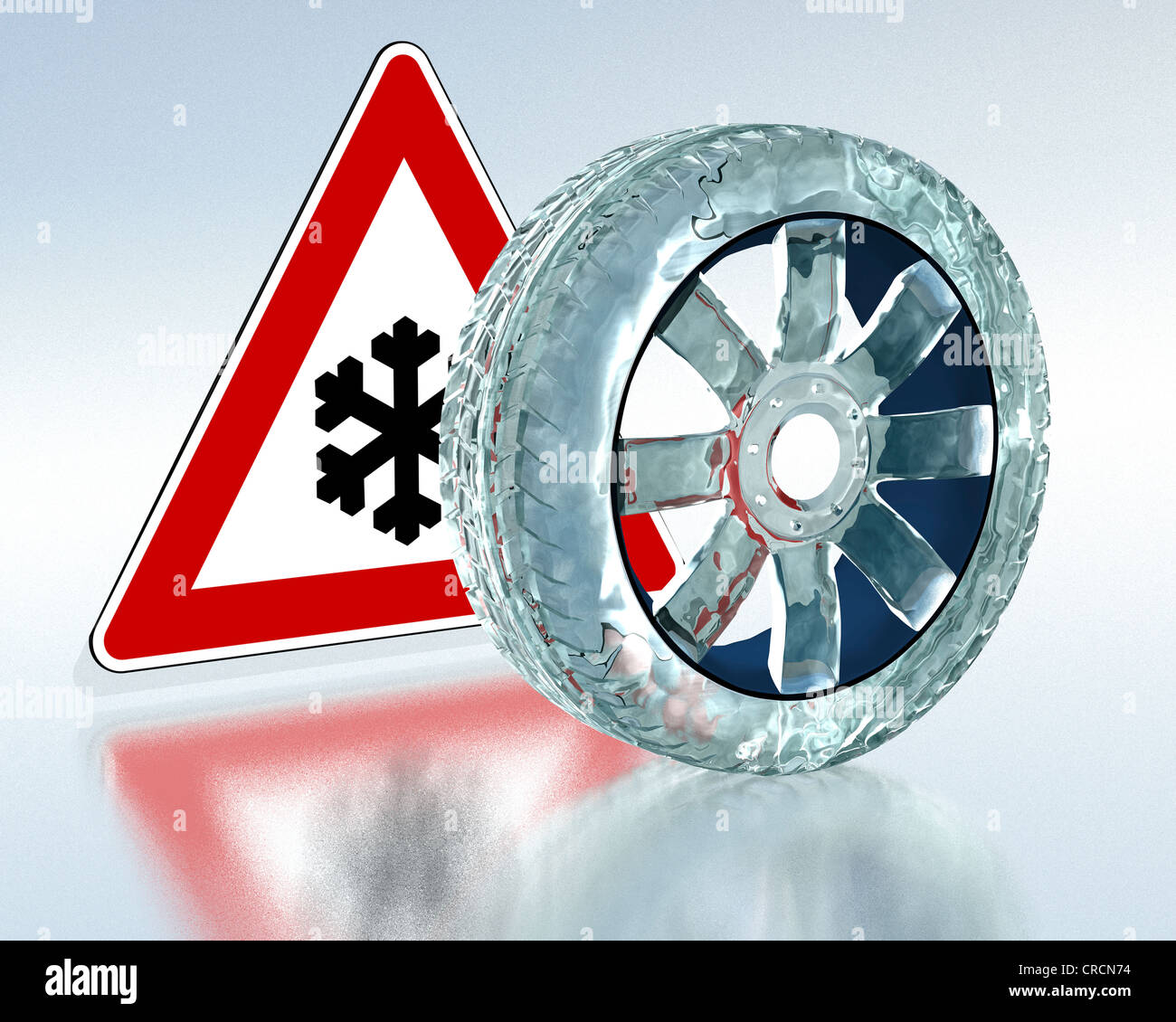 Car tyre made of ice with a traffic warning sign for snow and icy roads ...