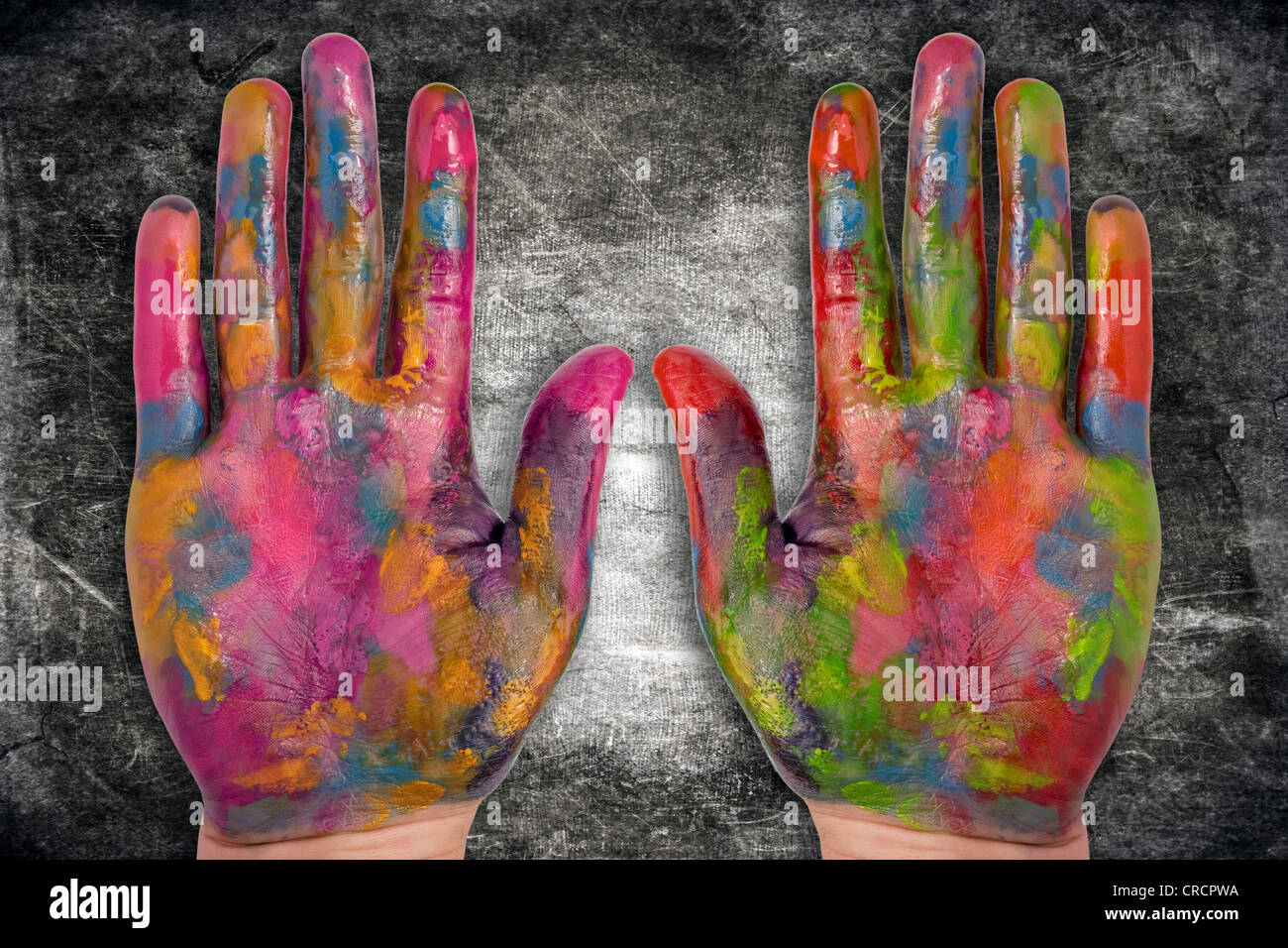 two painted human hands on dark background Stock Photo - Alamy