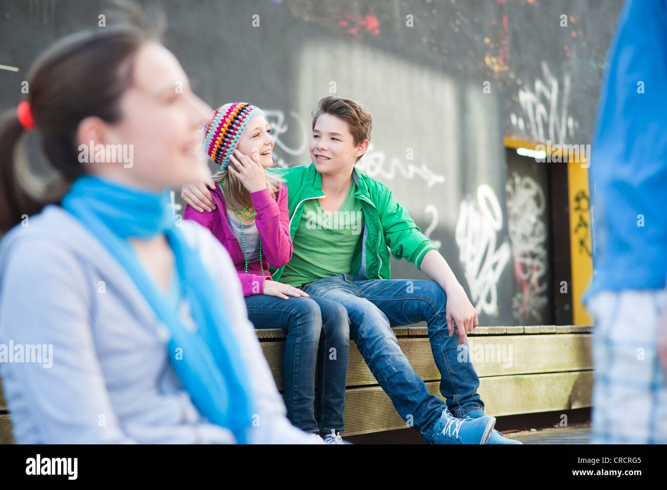 Smiling teenage boy embracing girlfriend Stock Photo - Alamy