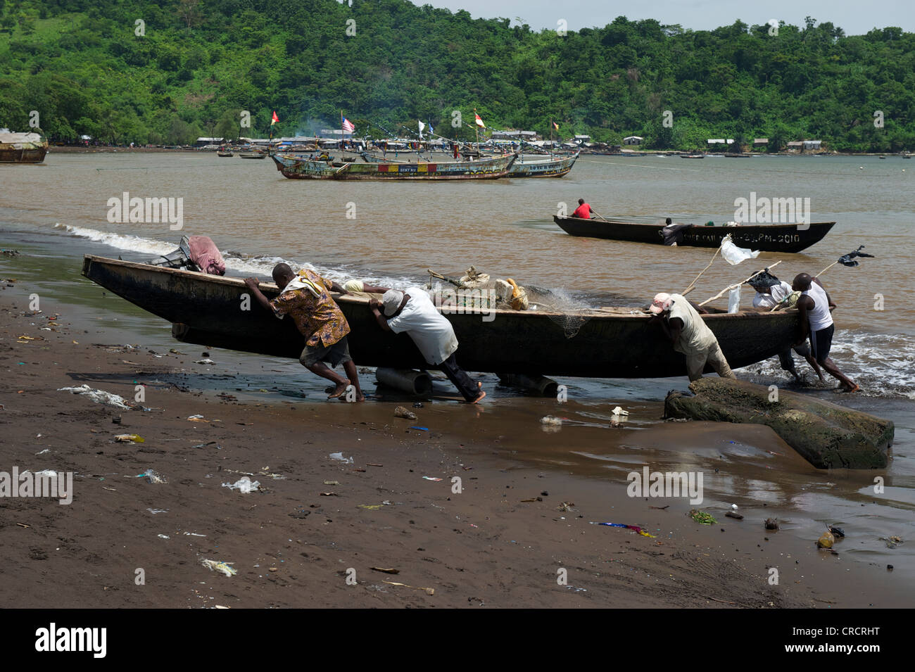 Fishermen pulling a boat ashore, Limbe, Cameroon, Africa Stock Photo ...