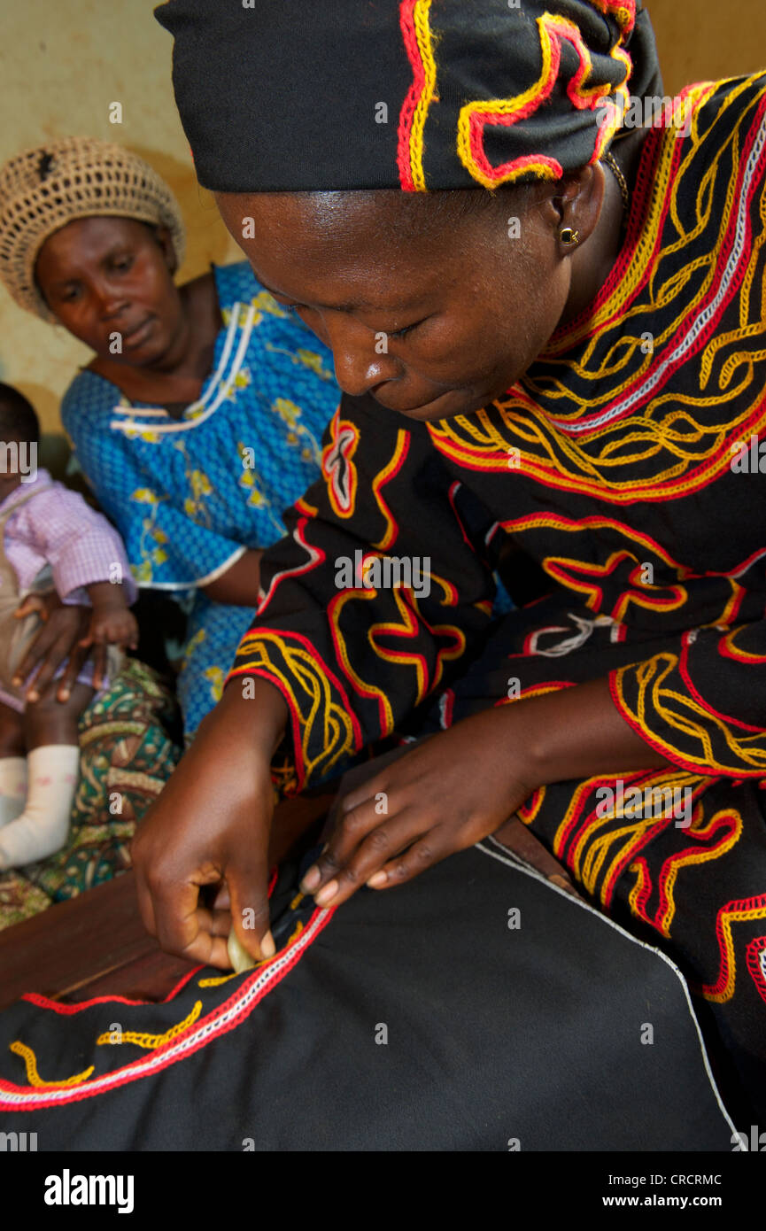Woman wearing traditional dress doing embroidery work, Bamenda ...