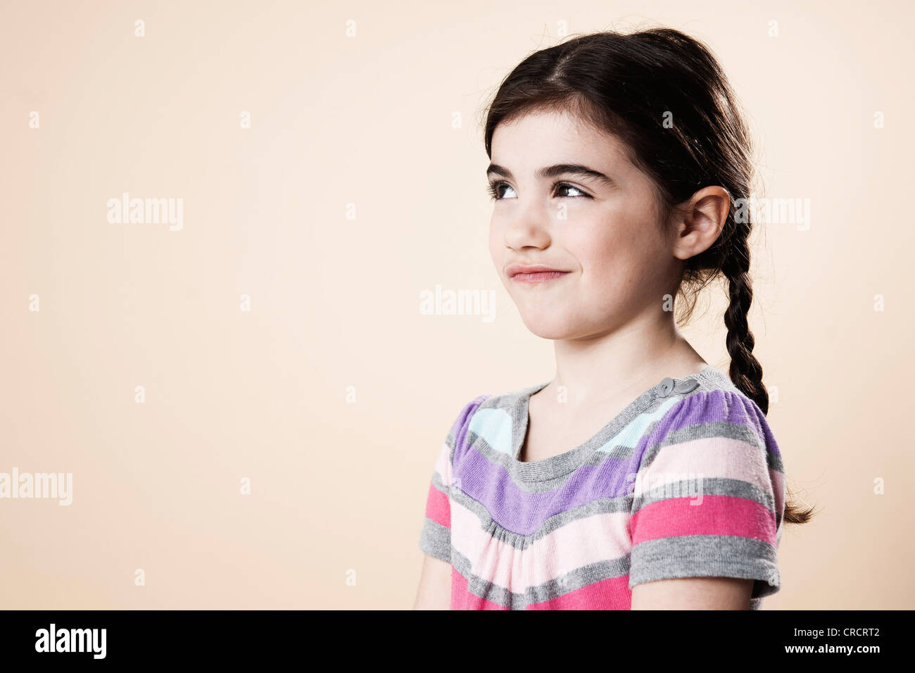 Grinning girl thinking Stock Photo - Alamy