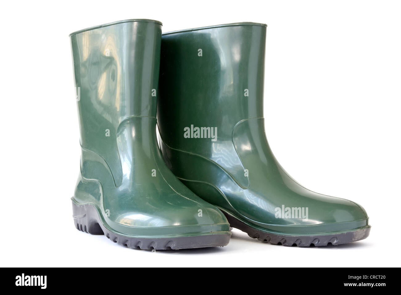 Green rubber boots over a white background Stock Photo - Alamy
