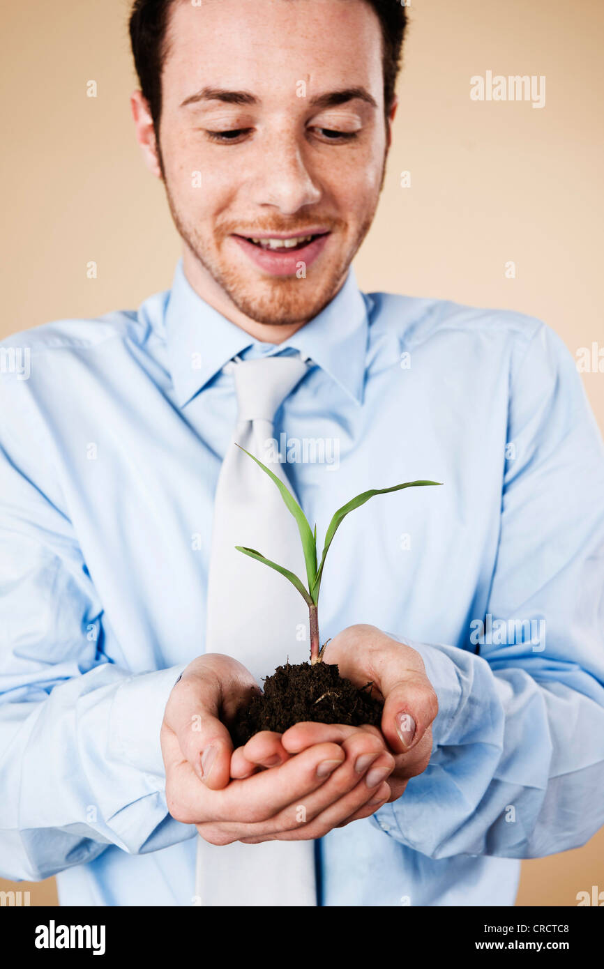 Young man with seedling Stock Photo - Alamy