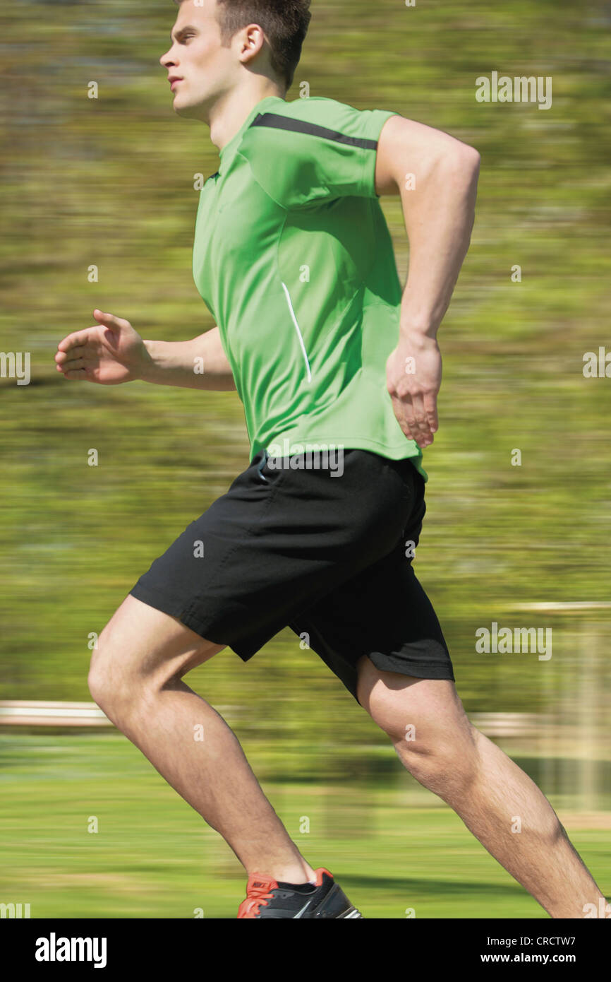 Man running over meadow Stock Photo - Alamy