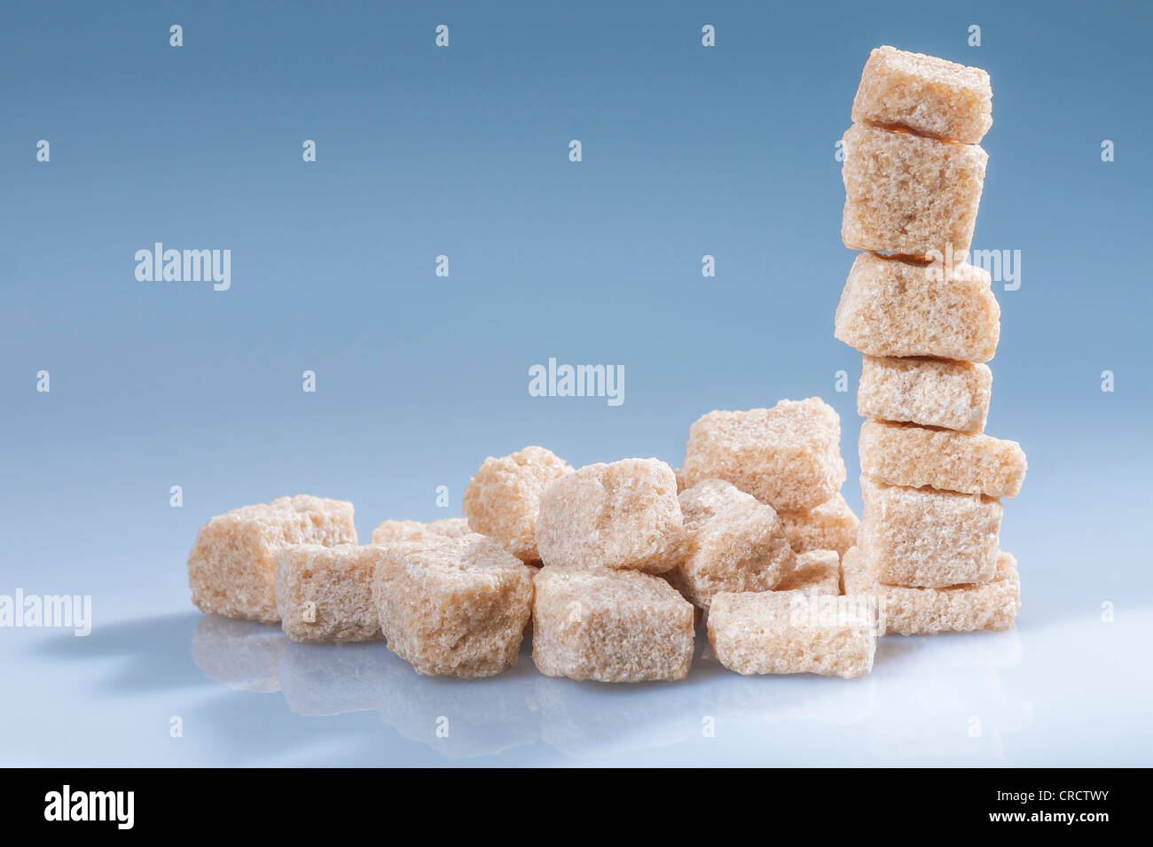 Vertical stack of brown sugar cubes on blue. Horizontal Stock Photo - Alamy