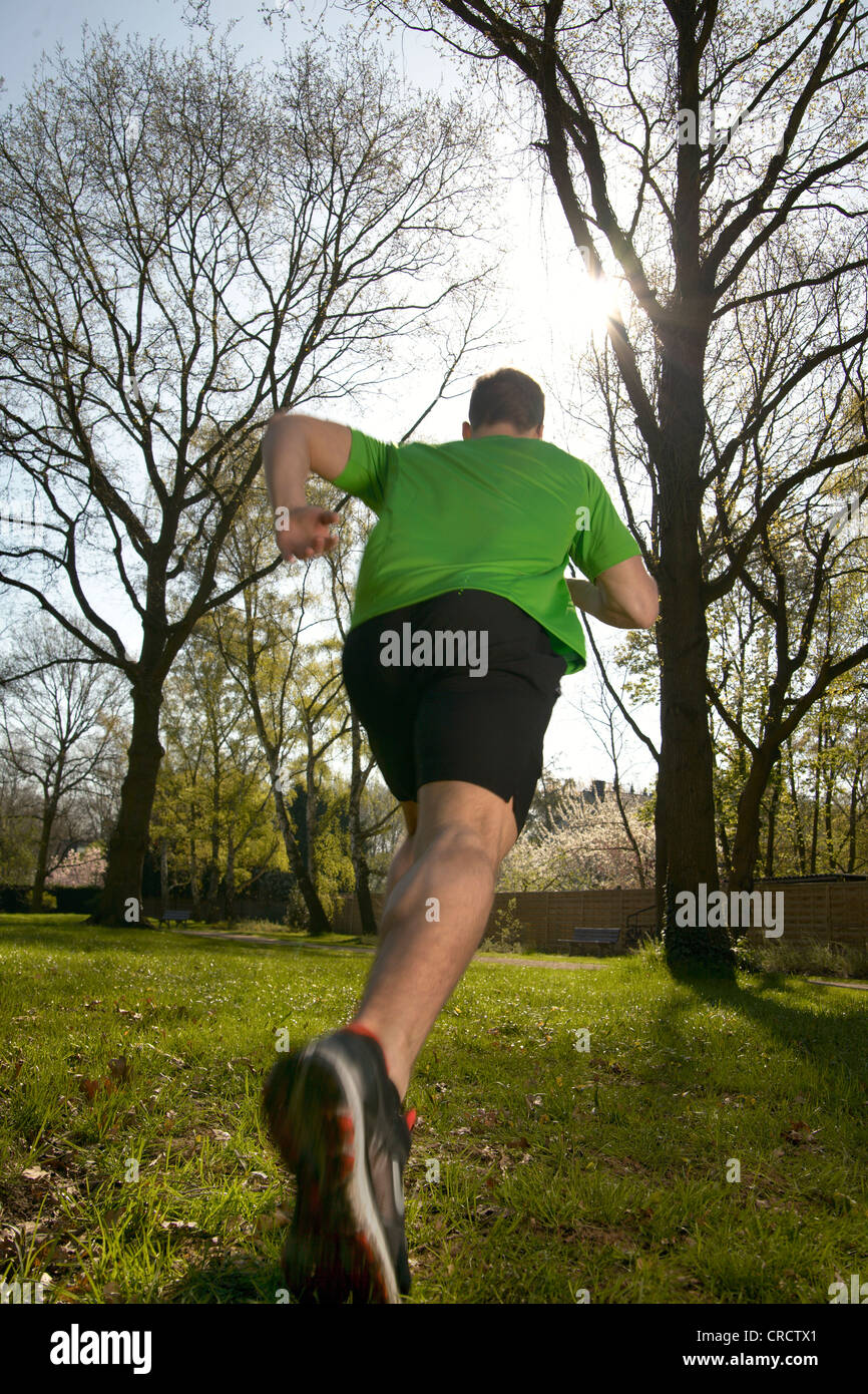 Man running over meadow Stock Photo - Alamy