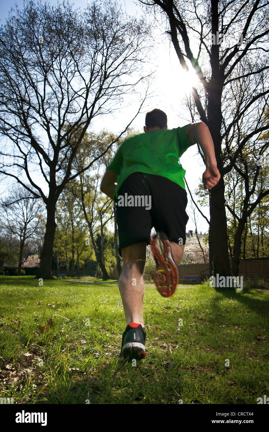 Man running over meadow Stock Photo - Alamy