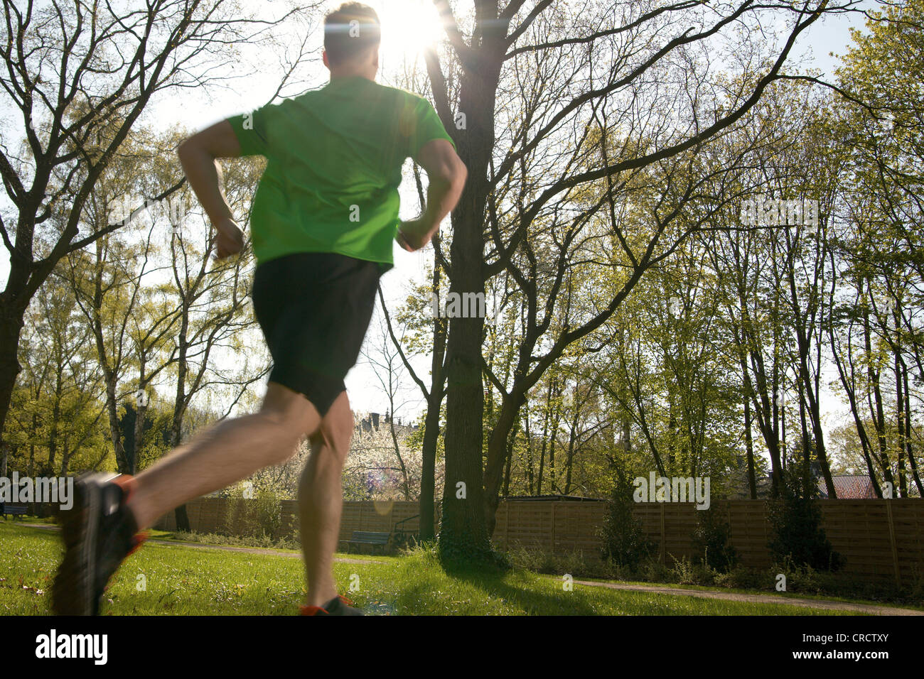 Man running over meadow Stock Photo - Alamy
