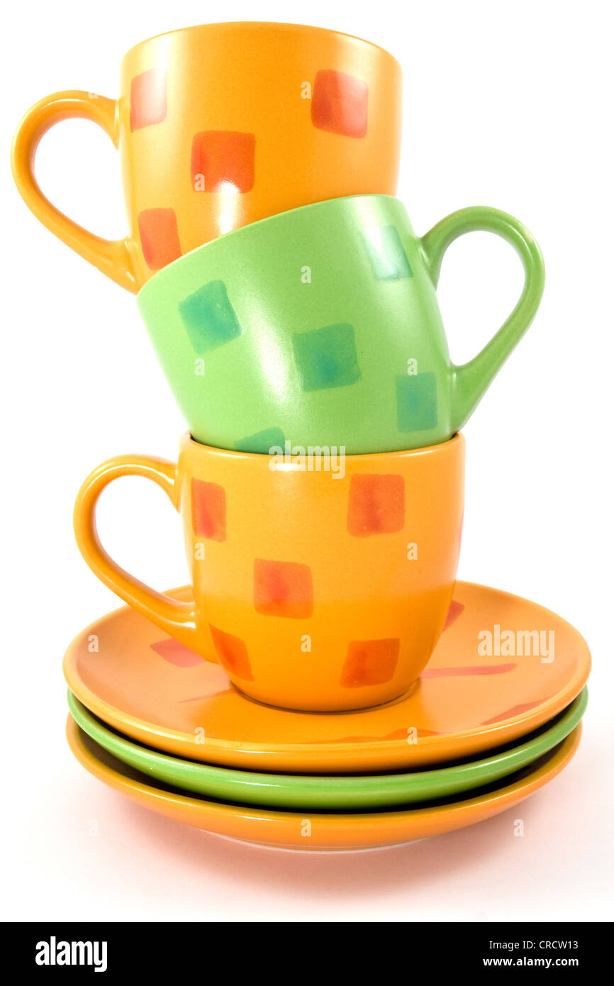 three colorful cups on a white background Stock Photo - Alamy