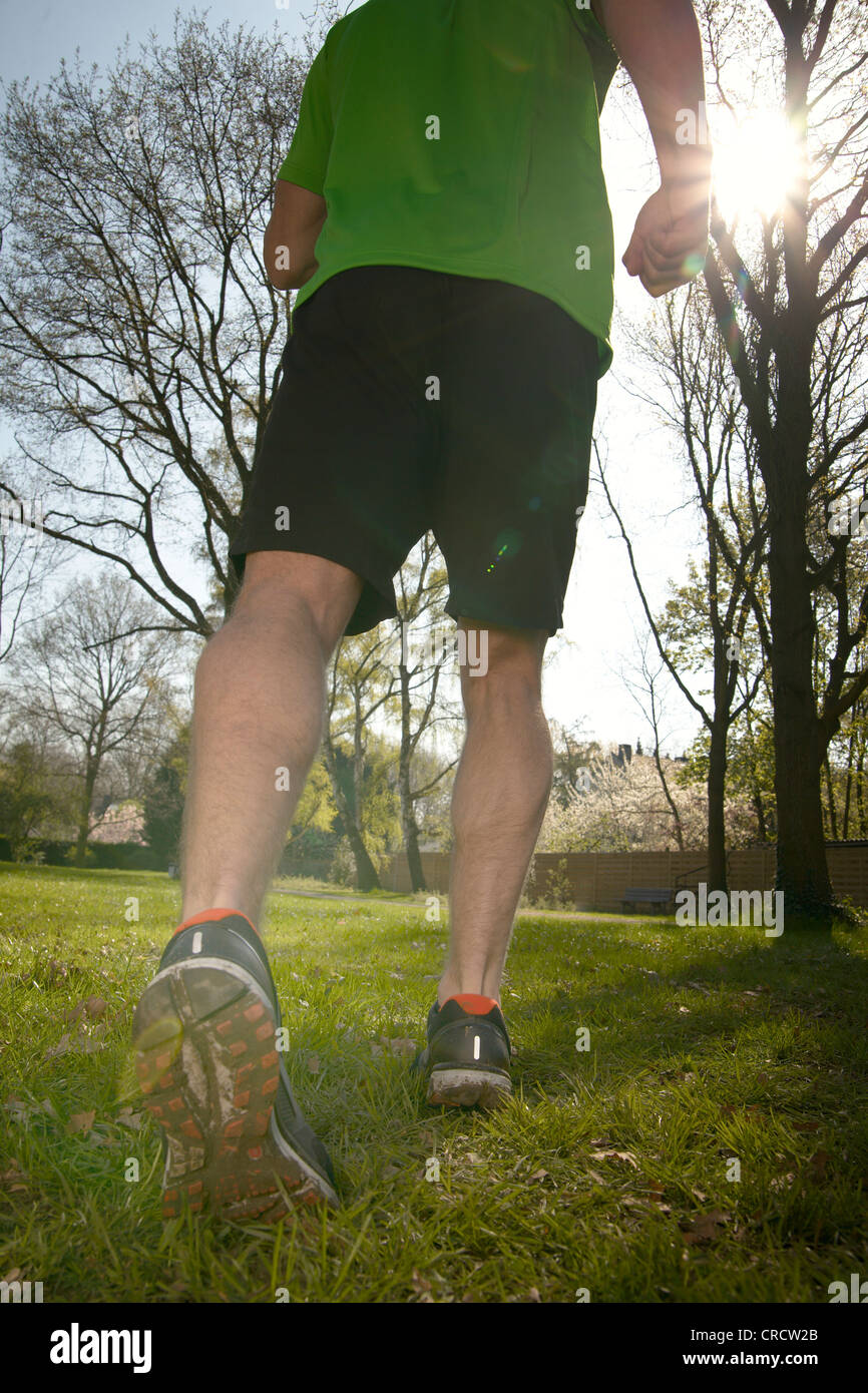Man running over meadow Stock Photo - Alamy
