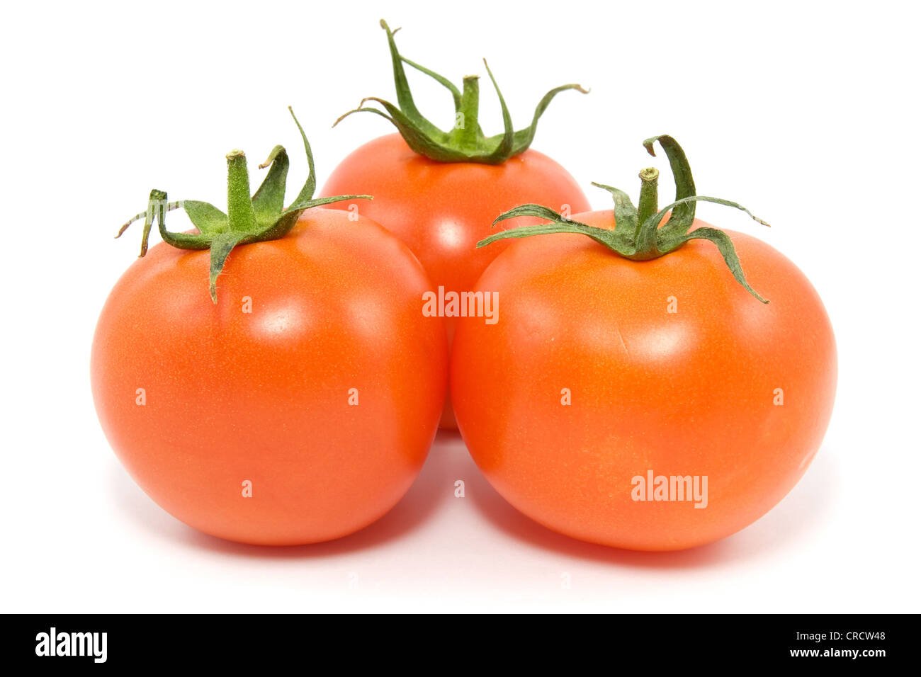 three red tomatoes isolated on white background Stock Photo - Alamy
