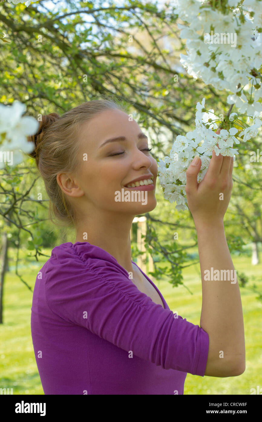 Woman smelling flower violet hi-res stock photography and images - Alamy