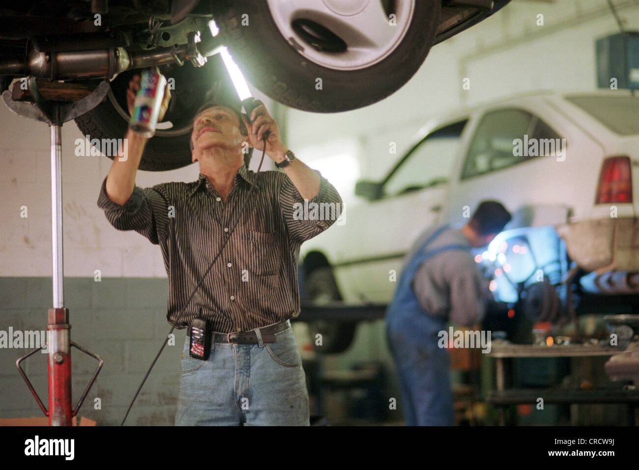 Auto repair shop, car mechanic at work Stock Photo - Alamy