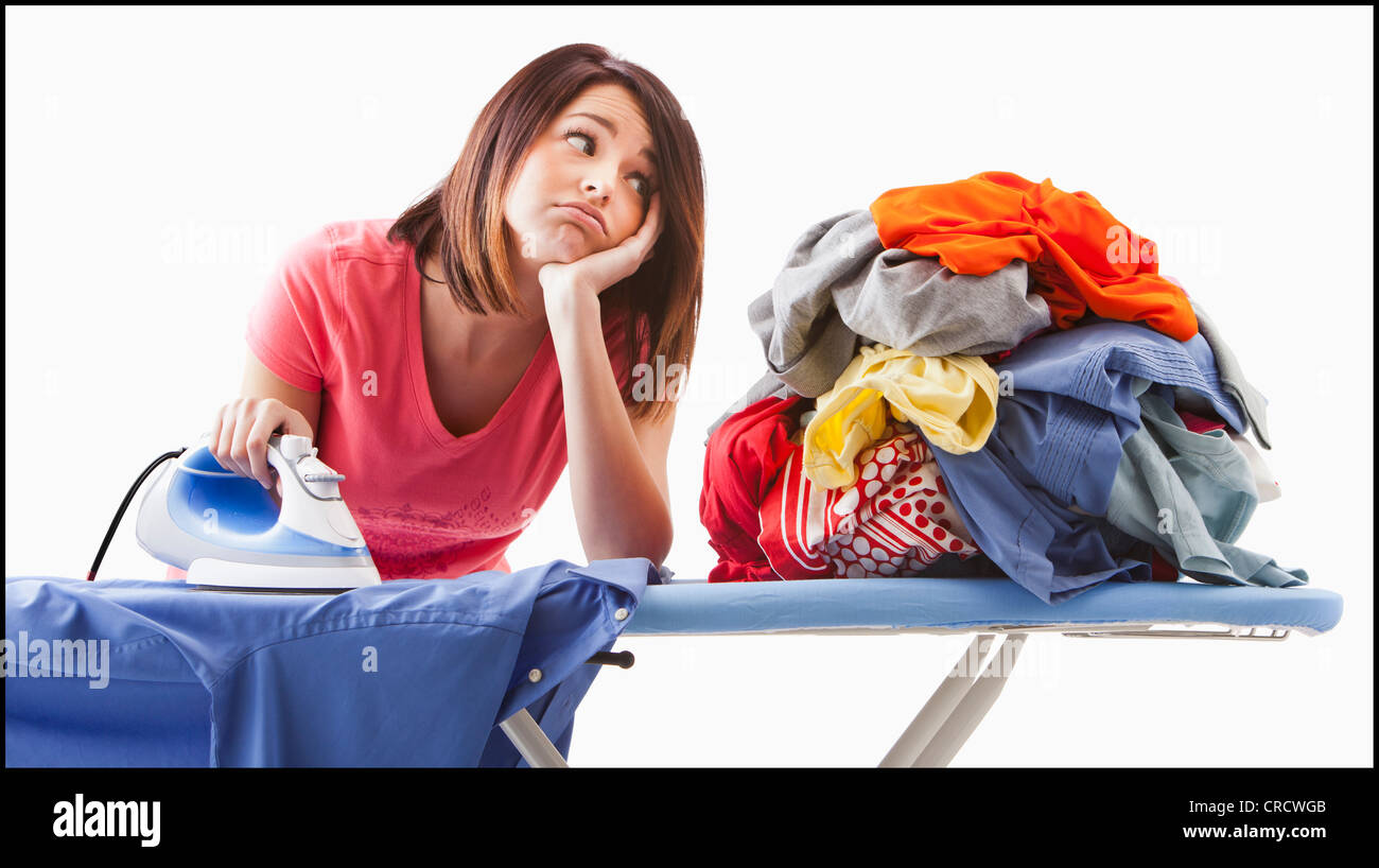 Young woman ironing Stock Photo - Alamy