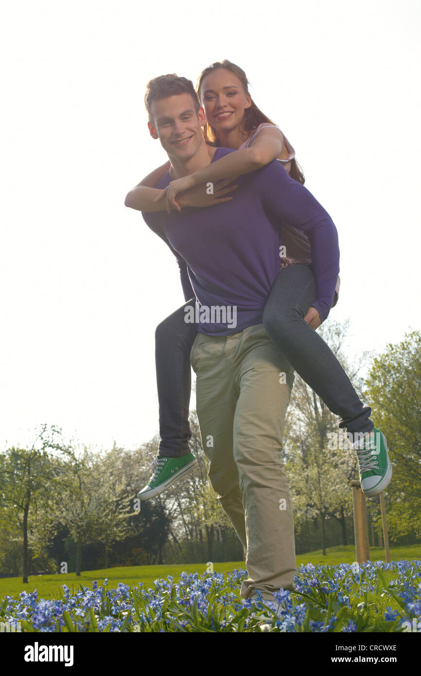 Man carrying woman piggyback Stock Photo - Alamy