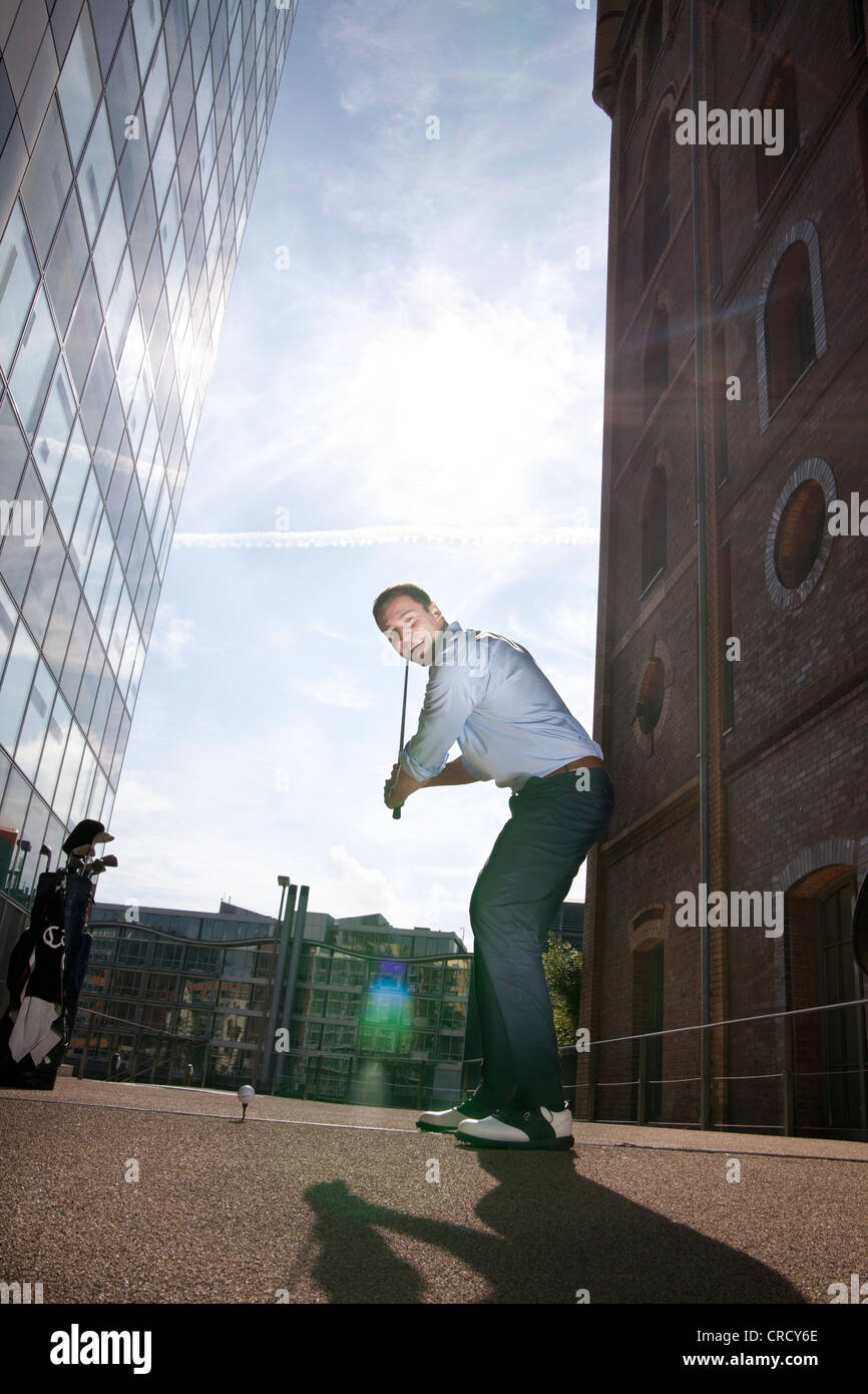 Man with golf club Stock Photo - Alamy