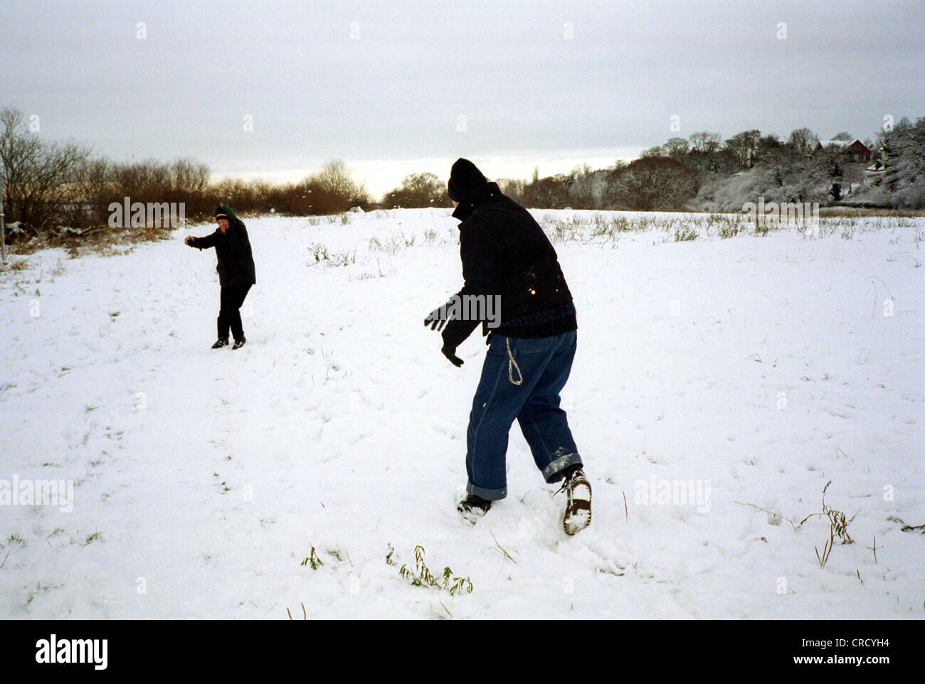 Snowball fight in a winter landscape Stock Photo - Alamy