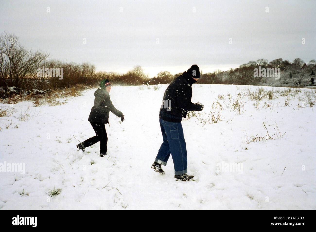 Snowball fight in a winter landscape Stock Photo - Alamy