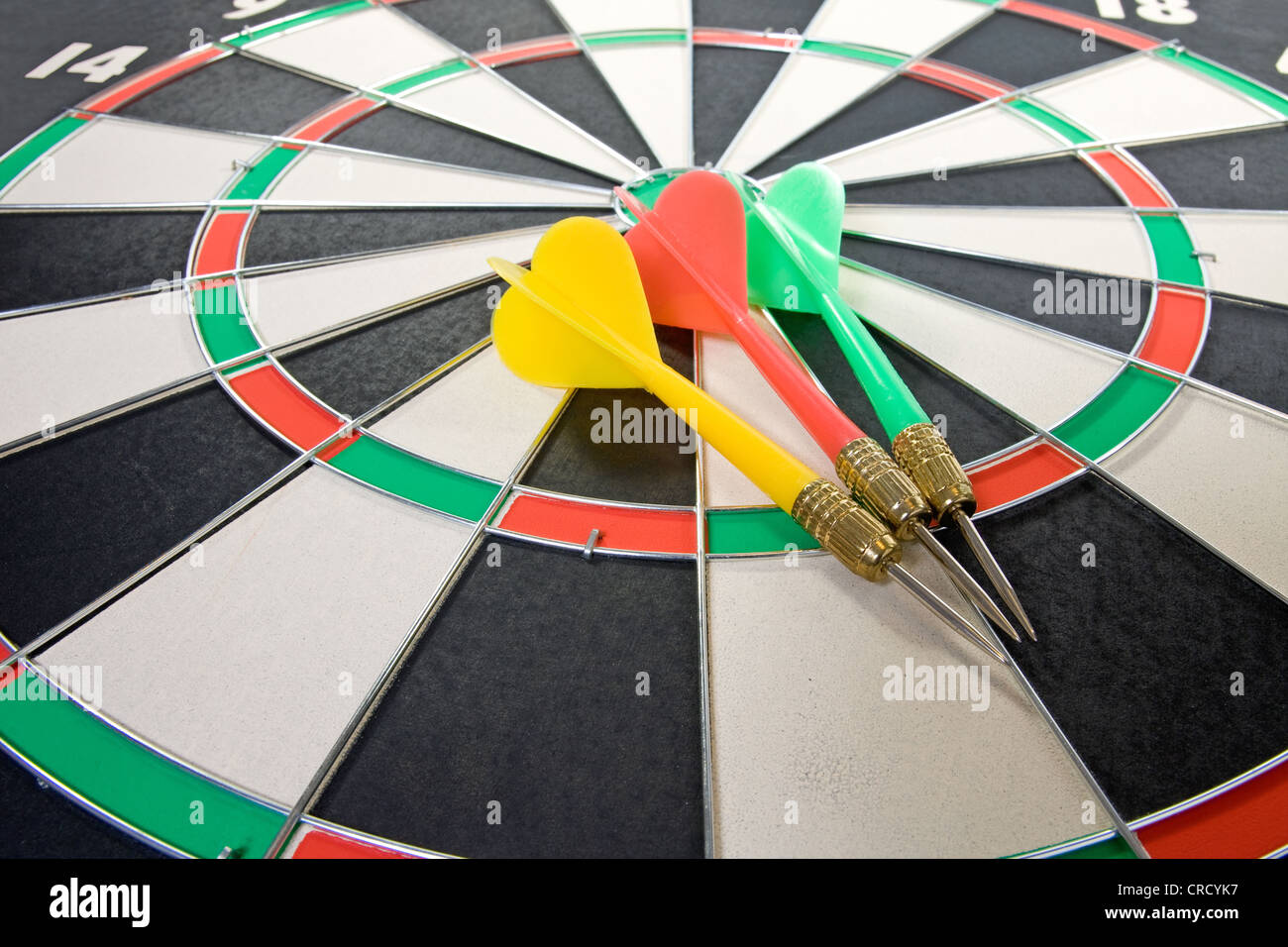 three color darts on the dart board Stock Photo - Alamy