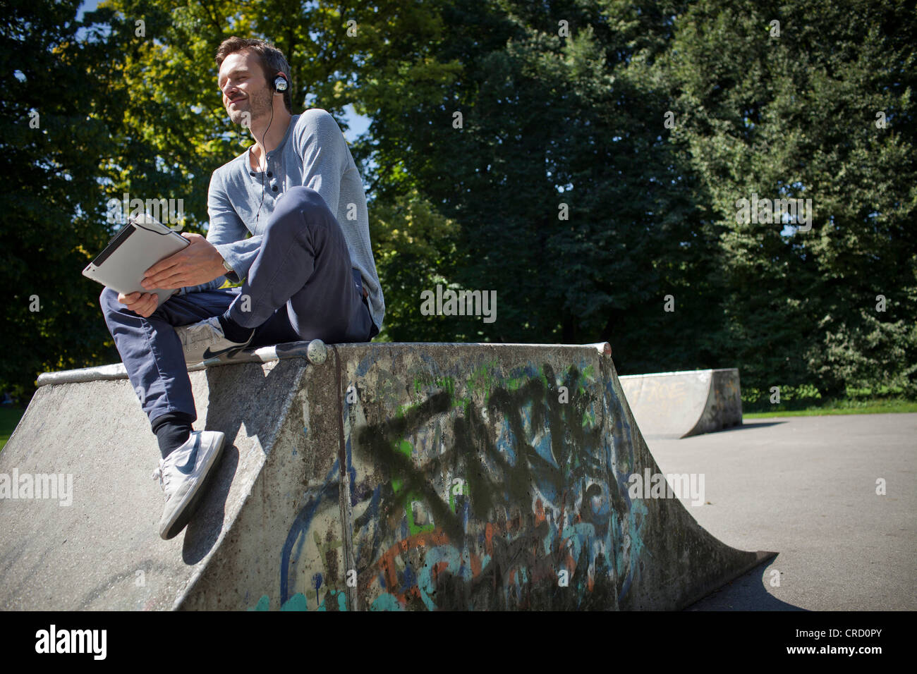 Man with ipad outdoors Stock Photo - Alamy